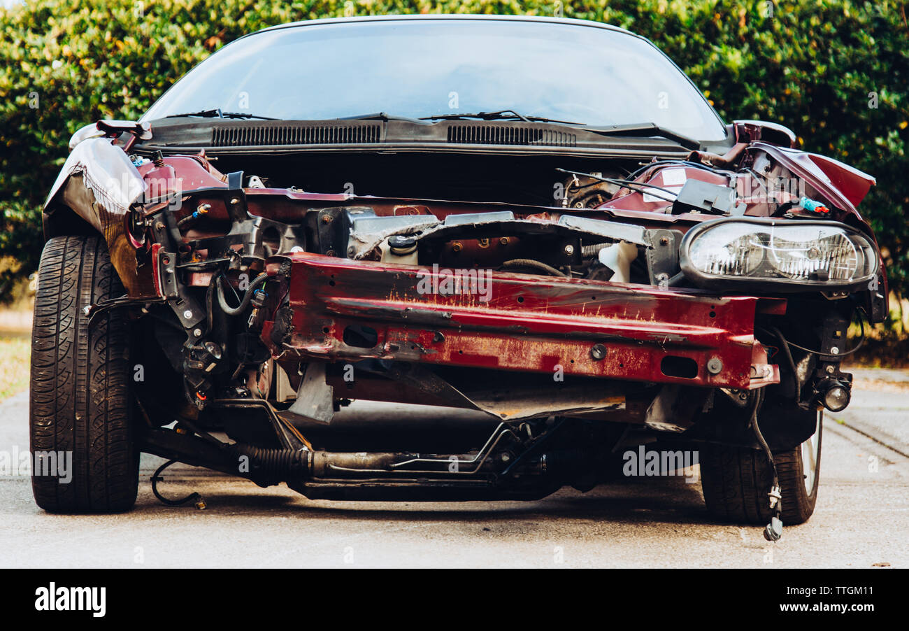 Front view of crashed muscle car damaged by stop sign Stock Photo - Alamy