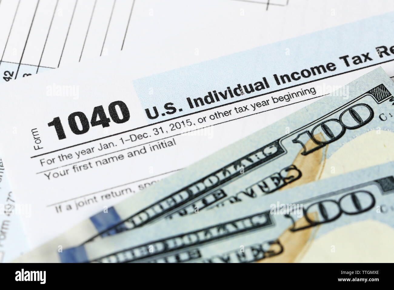 1040 Individual Income Tax Return Form with one hundred dollar bills ...