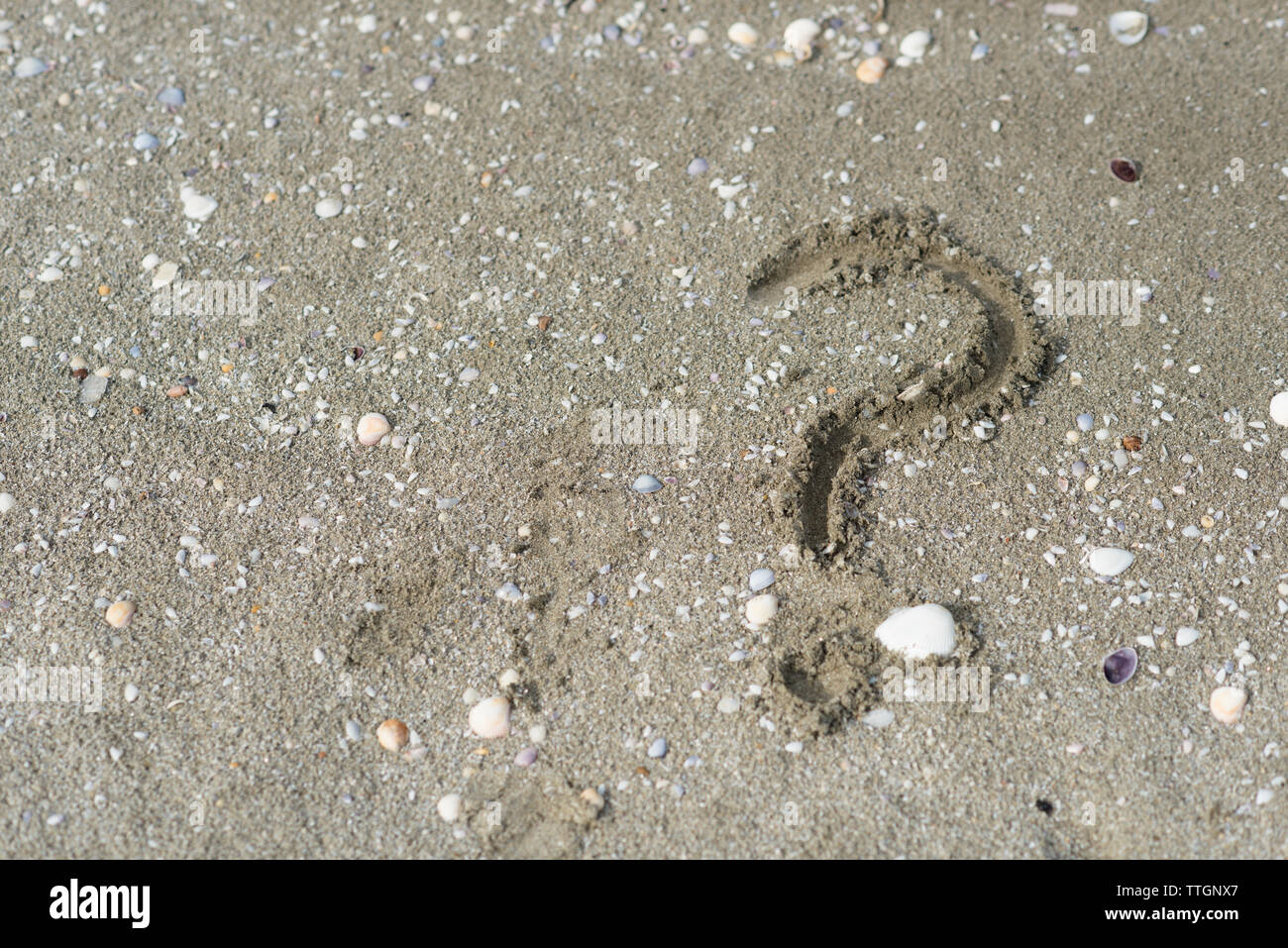 question mark wriiten on a sandy beach. Concept of faq, travel tips and ...