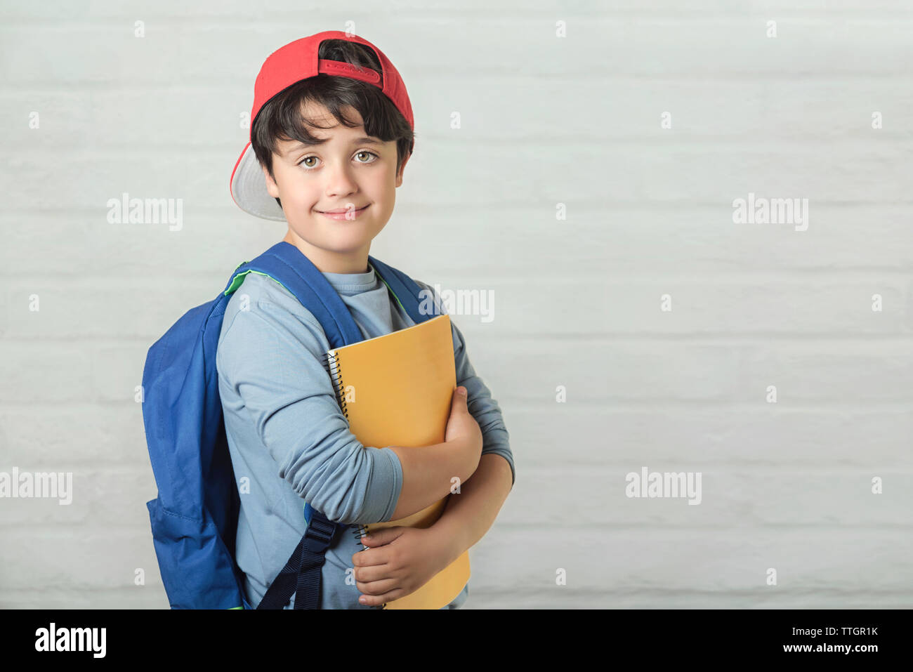 happy child with backpack and with notebook,back to school on brick ...