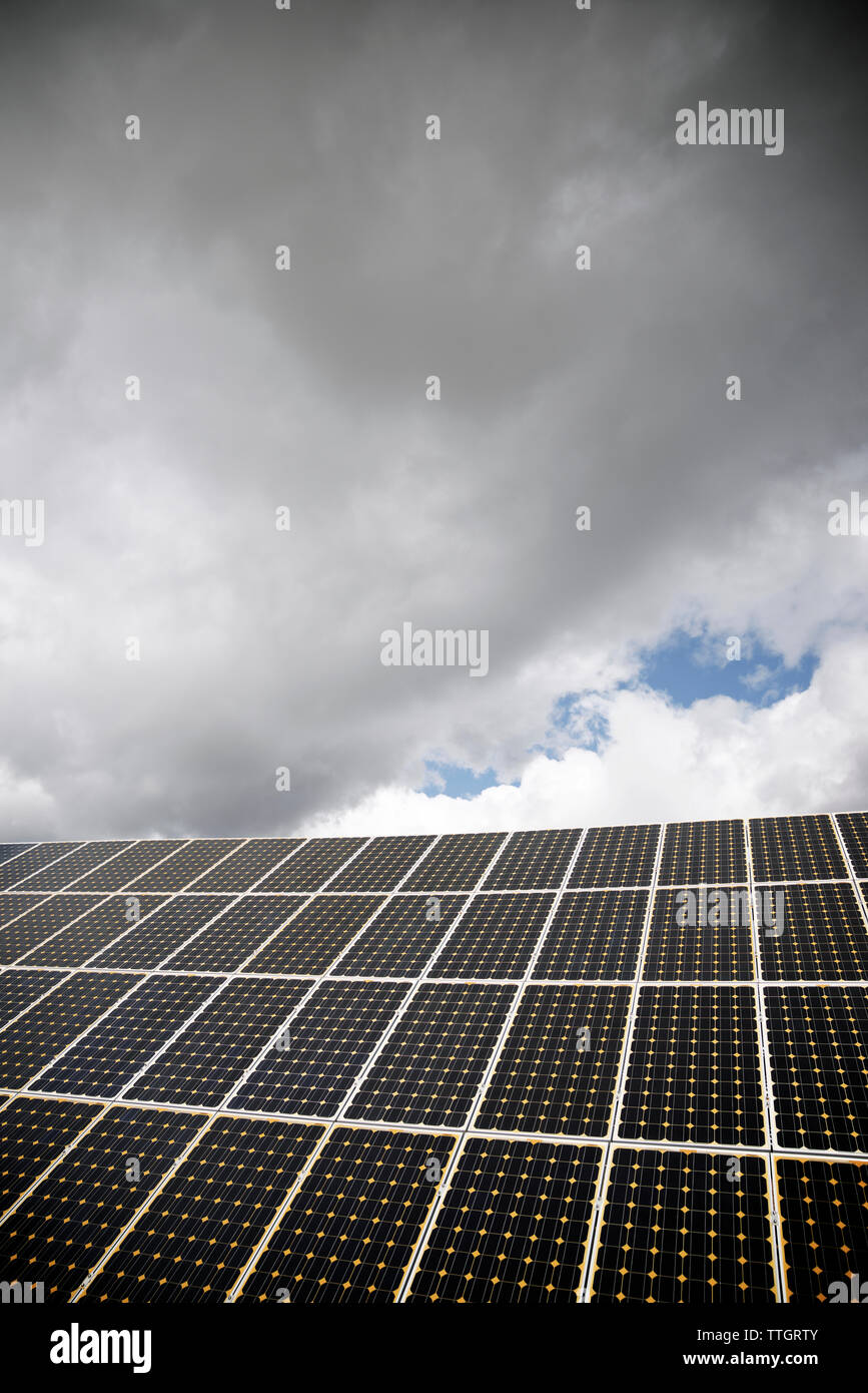 Low angle view of solar panels against cloudy sky Stock Photo - Alamy