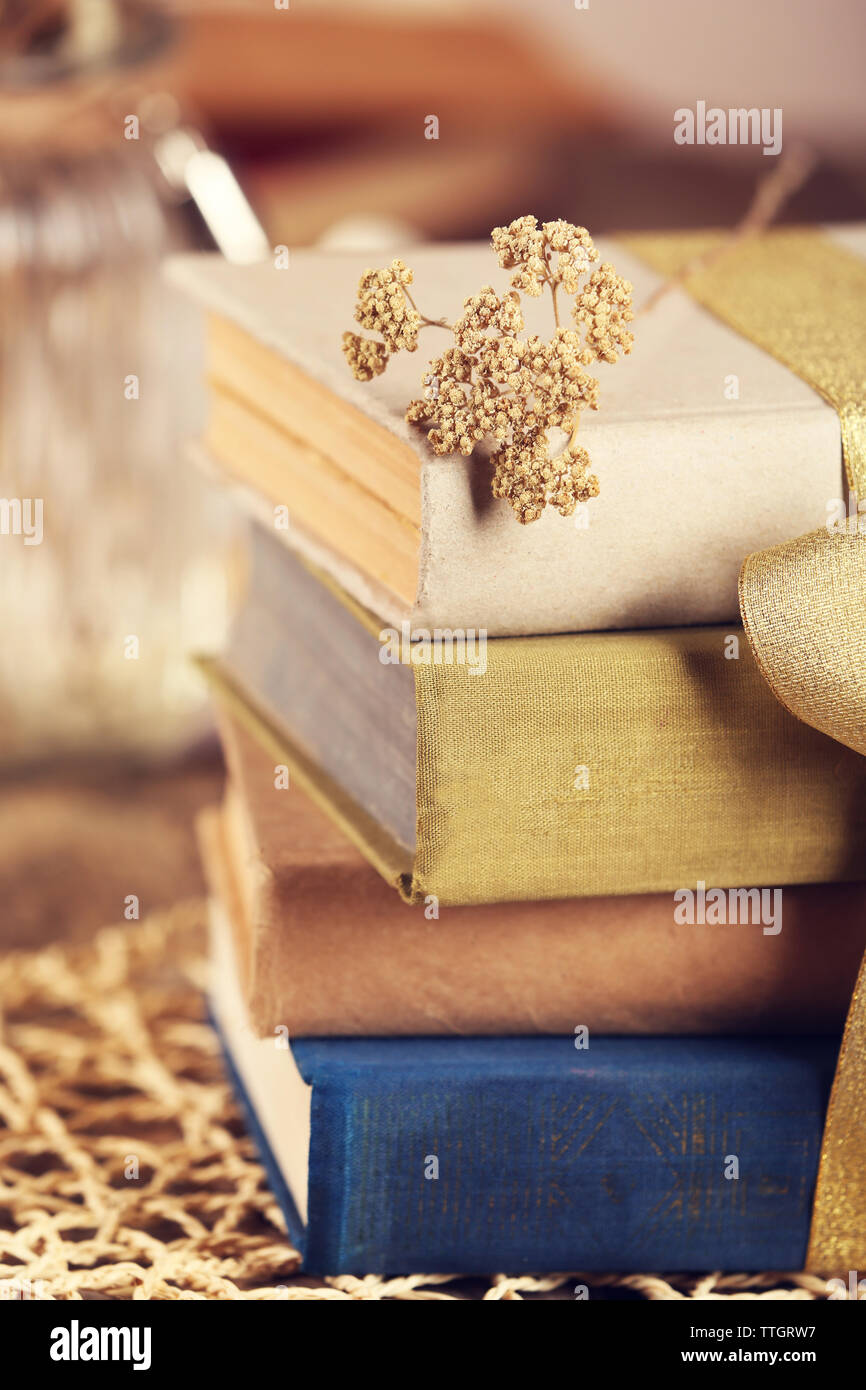 Stack of old books tied with yellow ribbon on a table, close up Stock ...