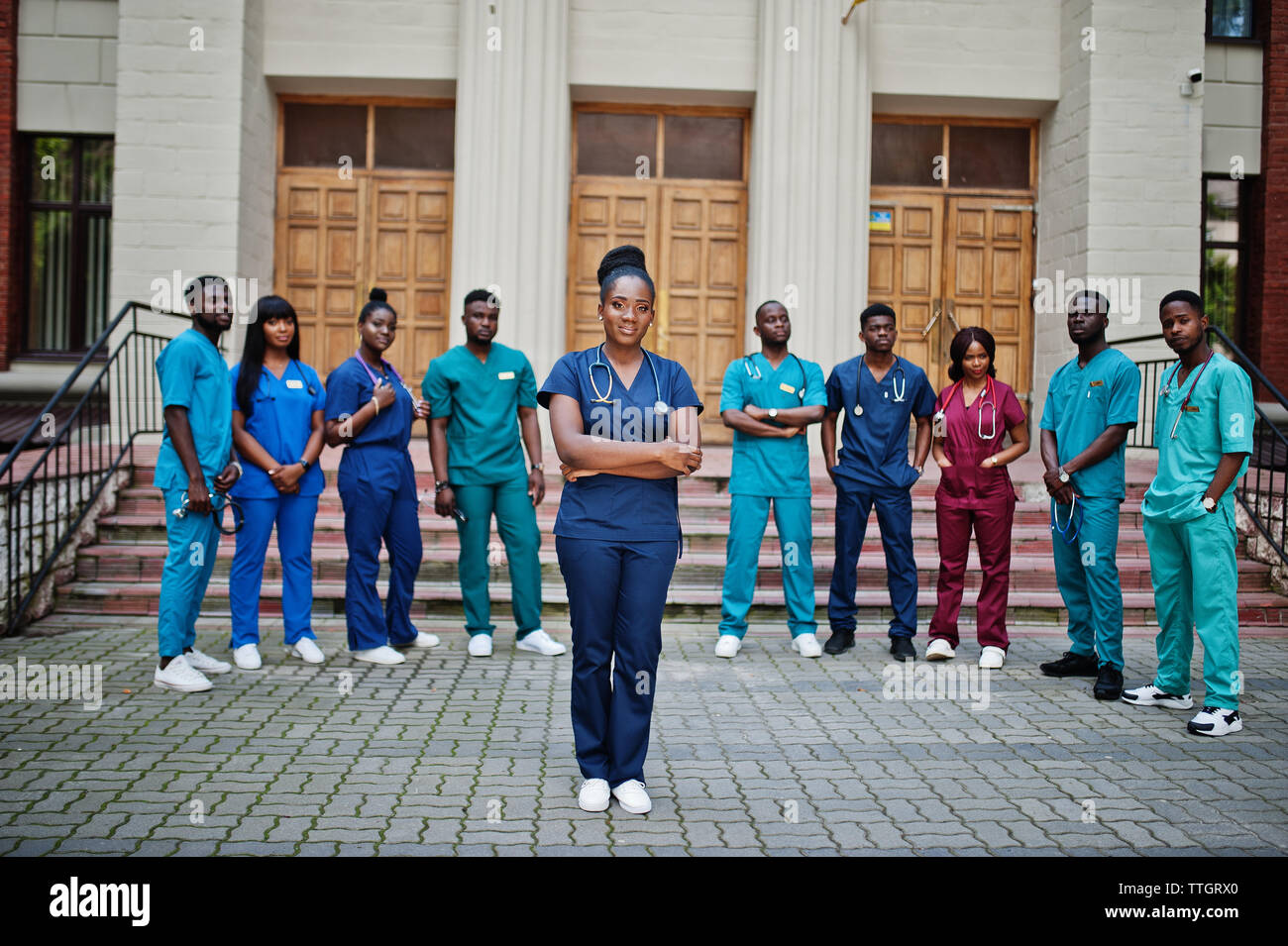 Group of african medical students posed outdoor against university door ...