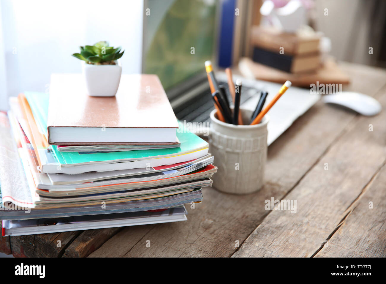 Workplace with laptop, table and books beside the window Stock Photo ...