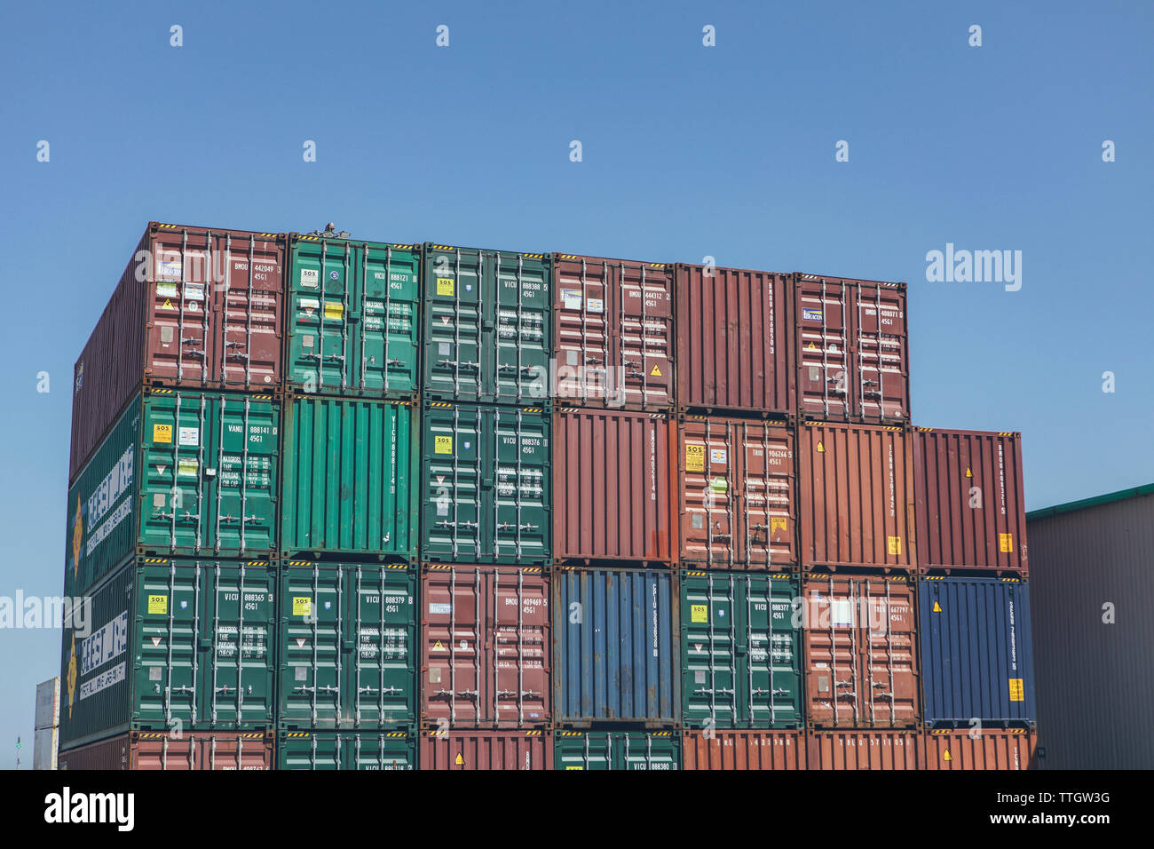 Ship containers against clear blue sky Stock Photo - Alamy