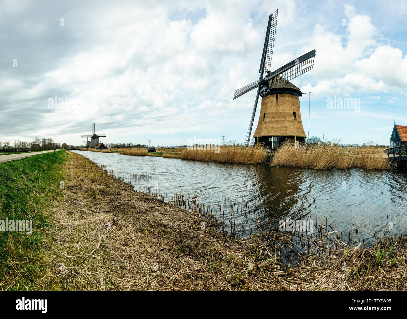 Traditional dutch mills over water canal in Holland country Stock Photo ...