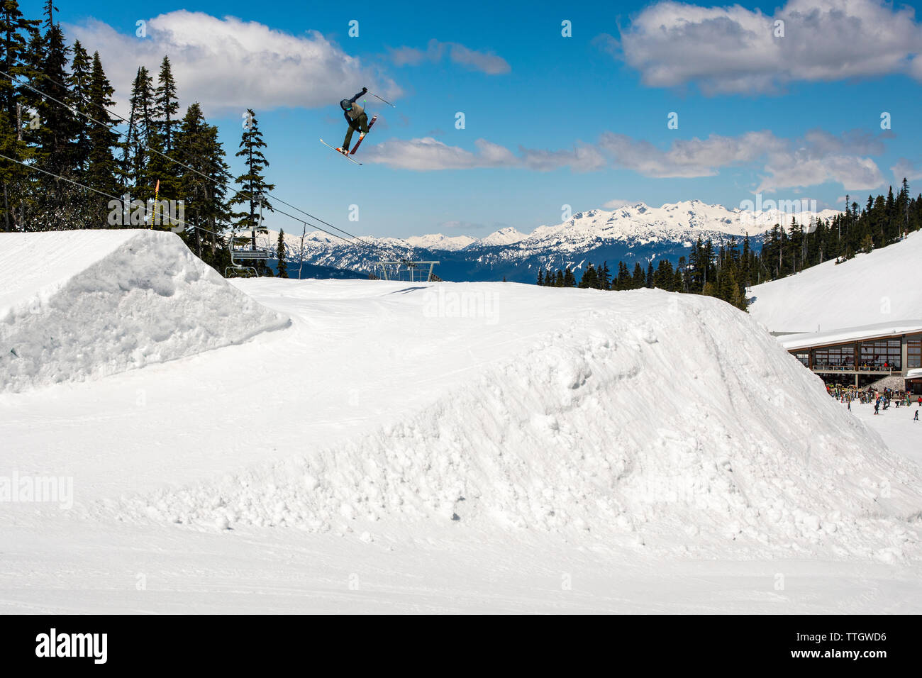 A man hits a jump on skis in the terrain park at Whistler Blackcomb ...