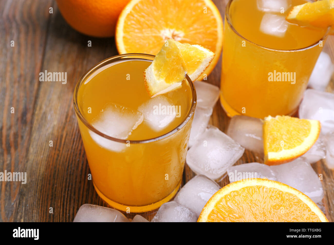 Two orange juices with cubes of ice and orange, closeup Stock Photo - Alamy
