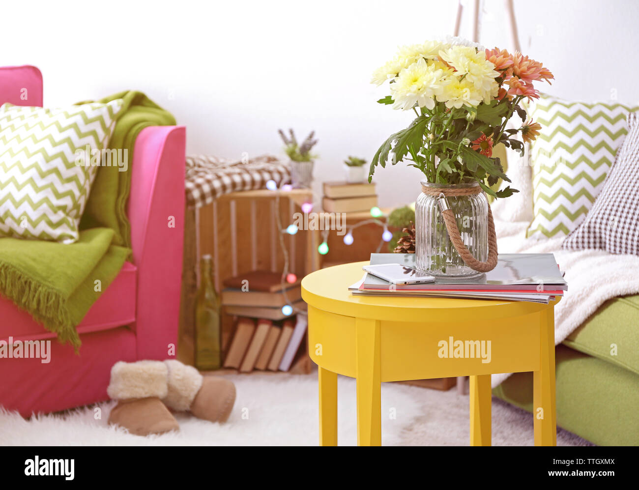 Interior of living room with beautiful flowers on table Stock Photo - Alamy