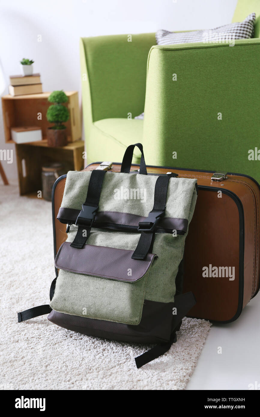 Suitcase and backpack in interior of living room, closeup Stock Photo ...