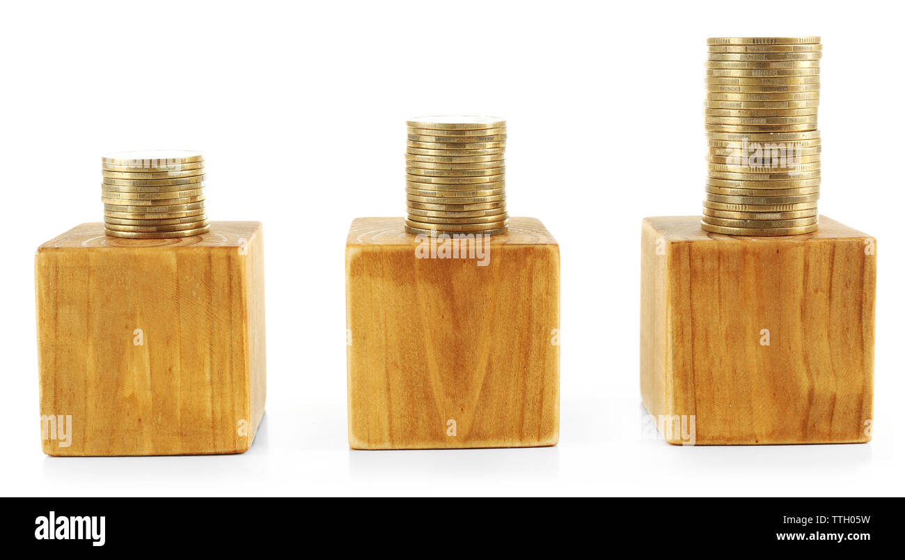 Wooden cubes with stacked coins isolated on white Stock Photo - Alamy