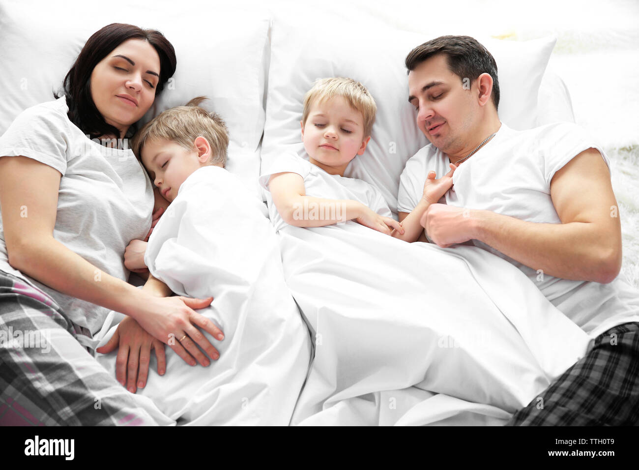 Family sleeping in bed, closeup Stock Photo - Alamy