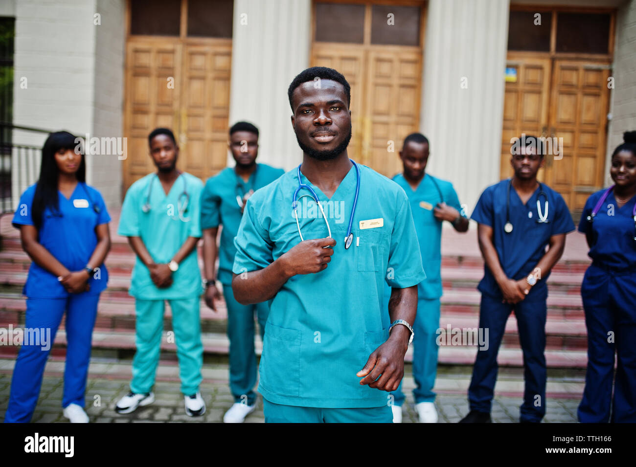 Group of african medical students posed outdoor against university door ...