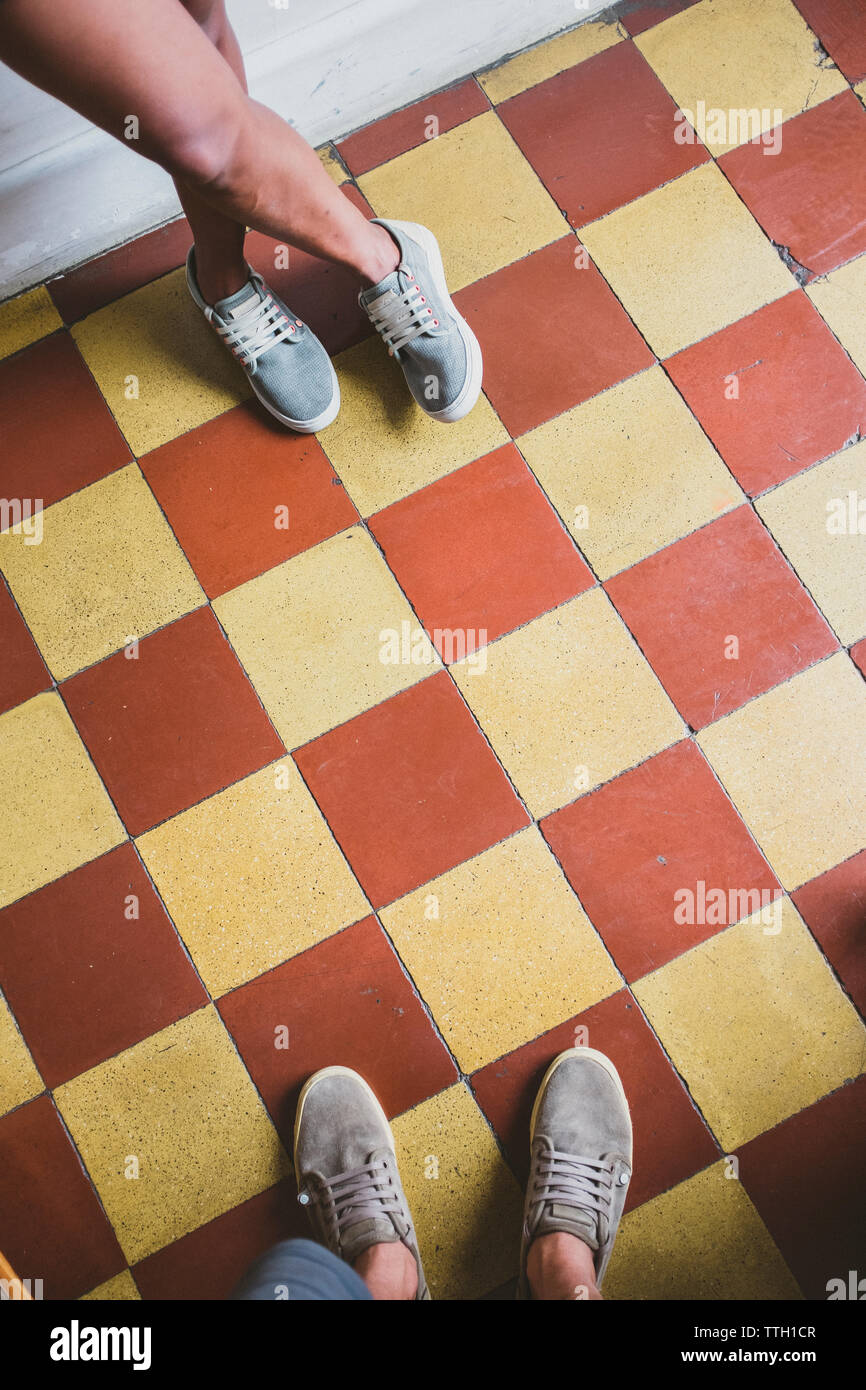 High angle view of women and men's feet on colorful tiled floor Stock ...