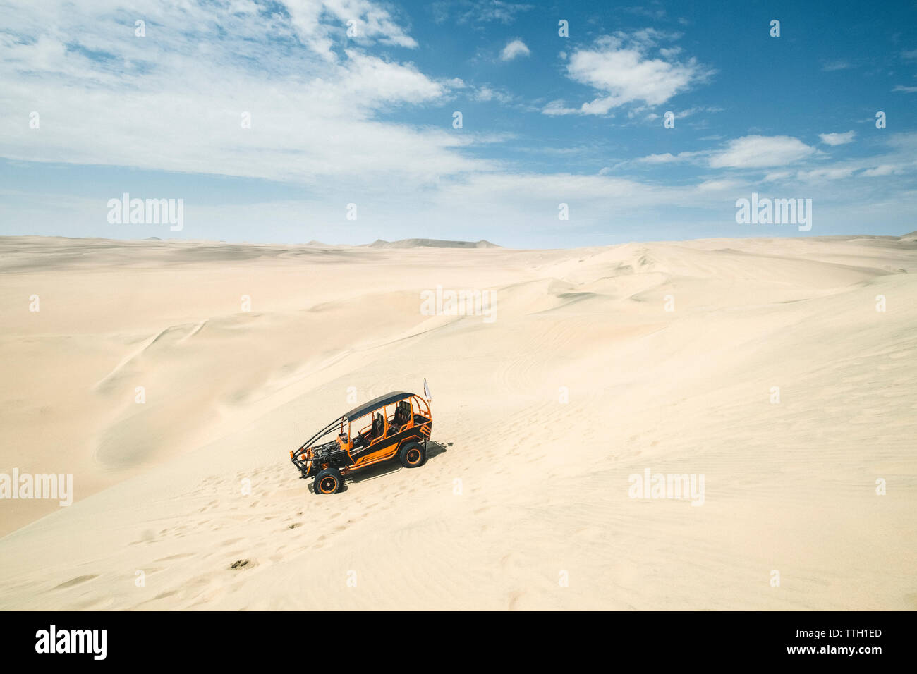 Pulled back view of a sand buggy in the middle of the desert Stock ...