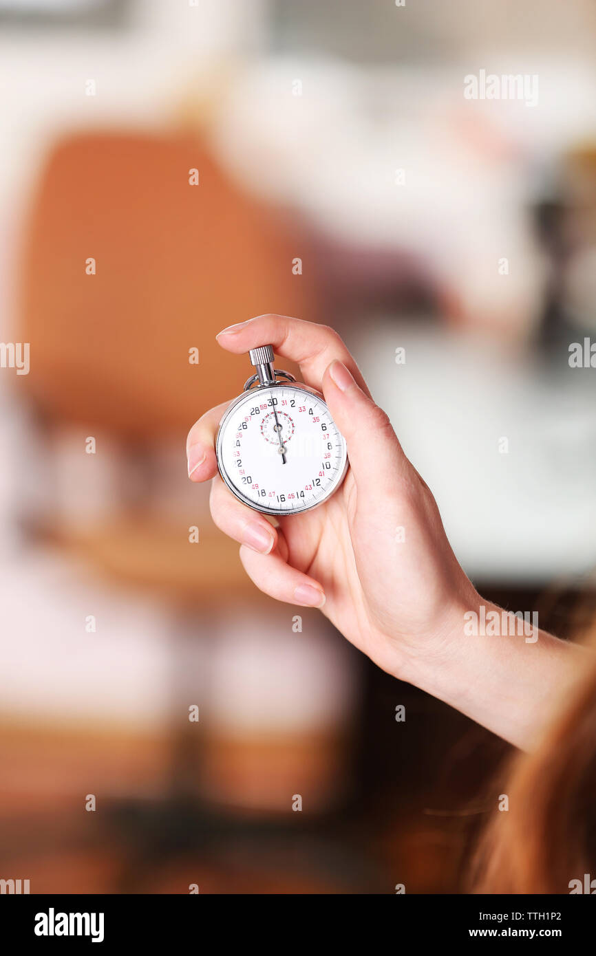 Woman holds stopwatch in hand, close up Stock Photo - Alamy