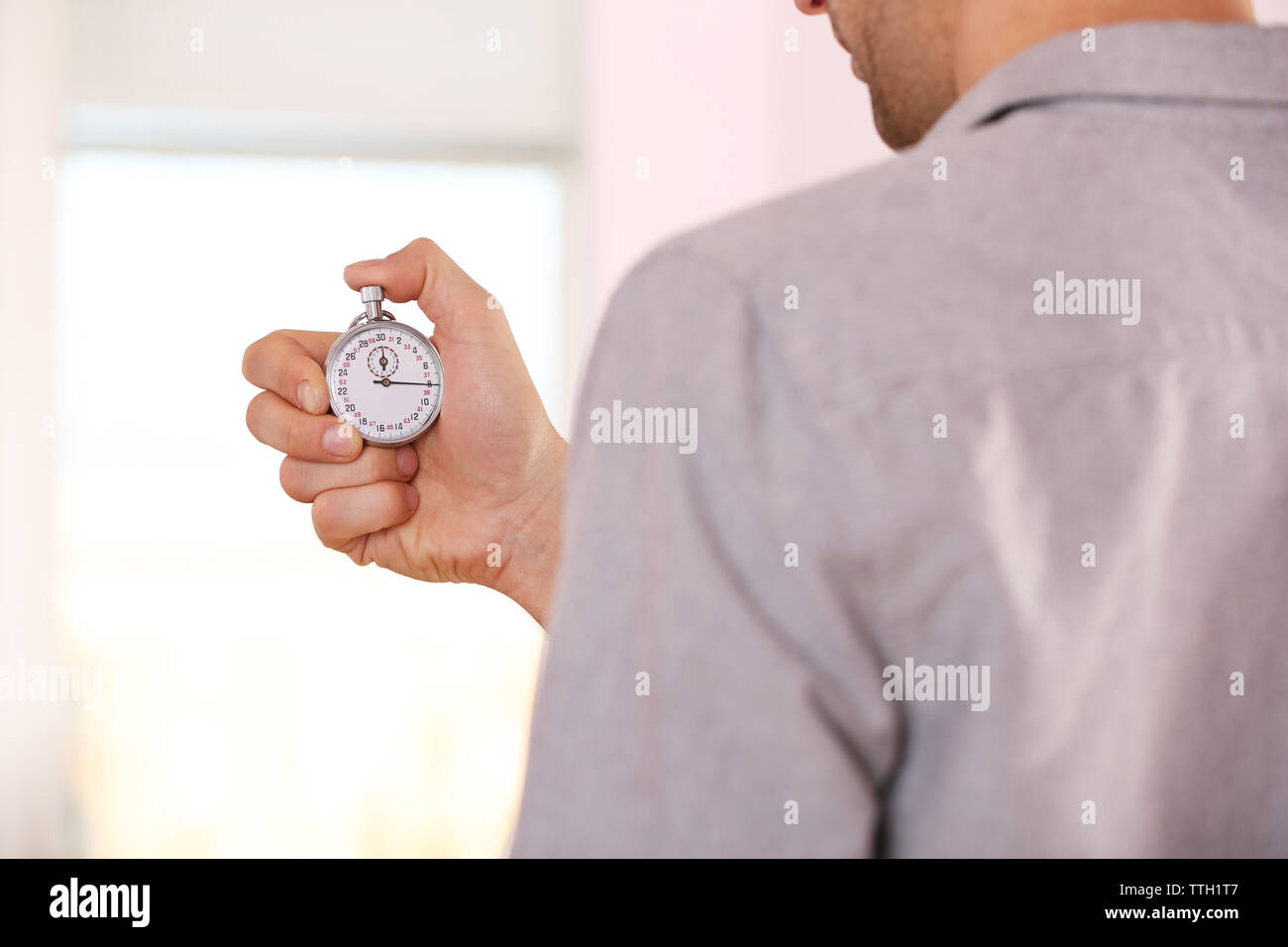 Man holds stopwatch in hand, close up Stock Photo - Alamy