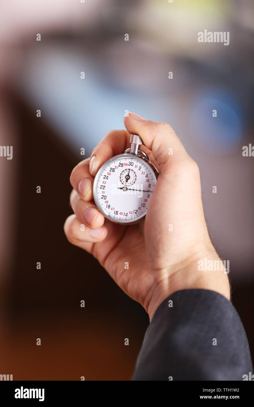 Man holds stopwatch in hand, close up Stock Photo - Alamy