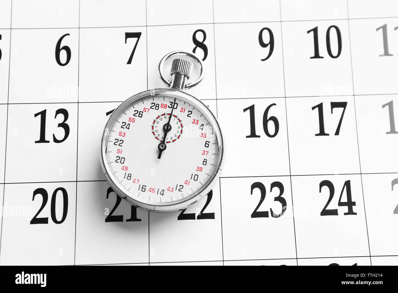 Stopwatch on calendar background, close up Stock Photo - Alamy