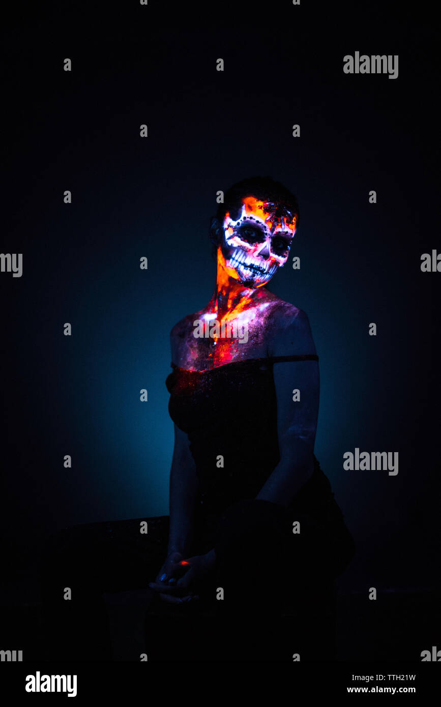 Girl's face painted UV skull Stock Photo - Alamy