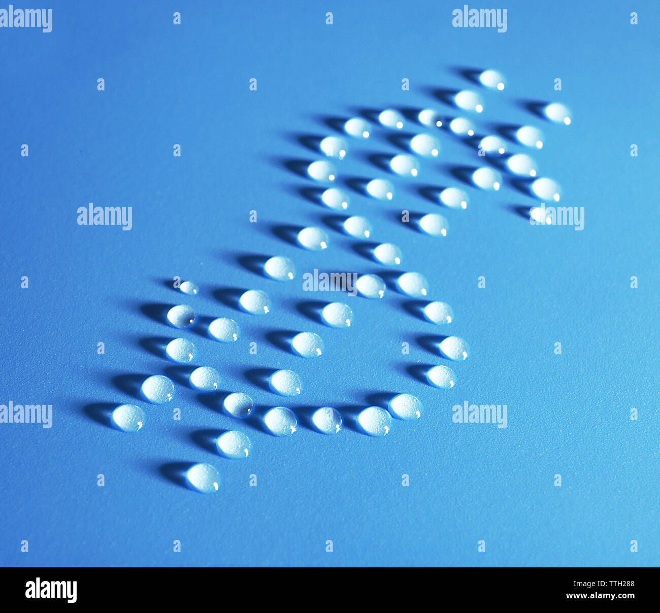 Dollar sign made of water drops on blue background Stock Photo - Alamy