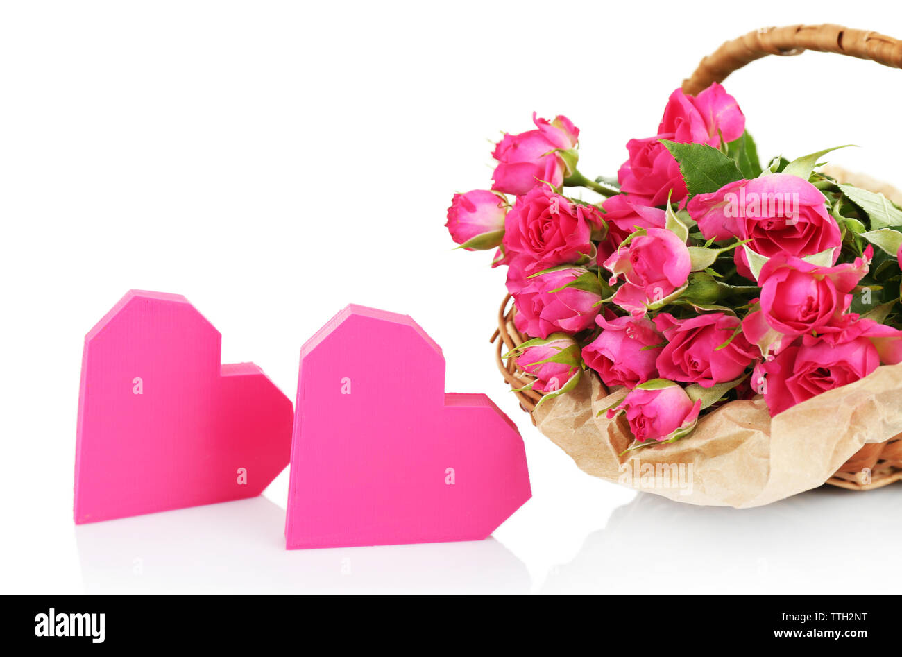 Basket filled with pink roses isolated on white Stock Photo - Alamy