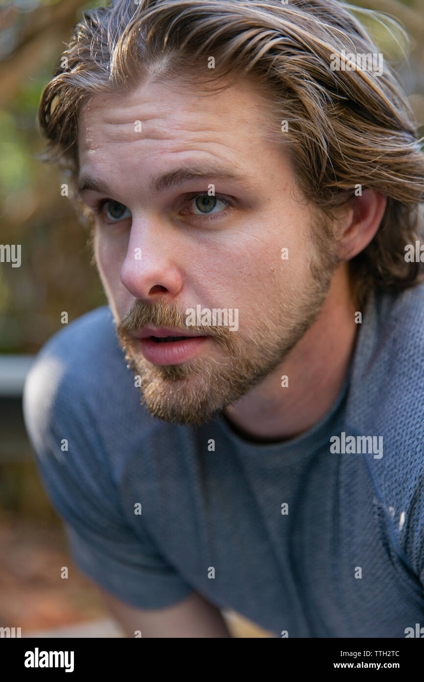 Close up portrait of a young caucasian man while a beard and long hair ...