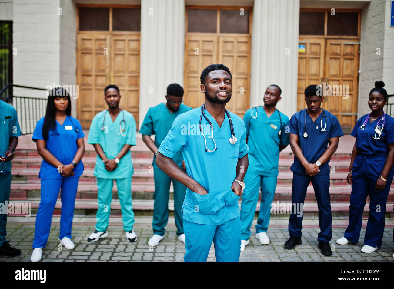 Group of african medical students posed outdoor against university door ...