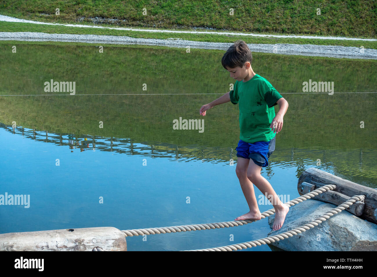Boy balancing on an outdoor playground Stock Photo - Alamy