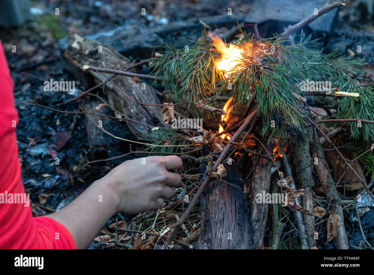 Woman starting campfire hi-res stock photography and images - Alamy