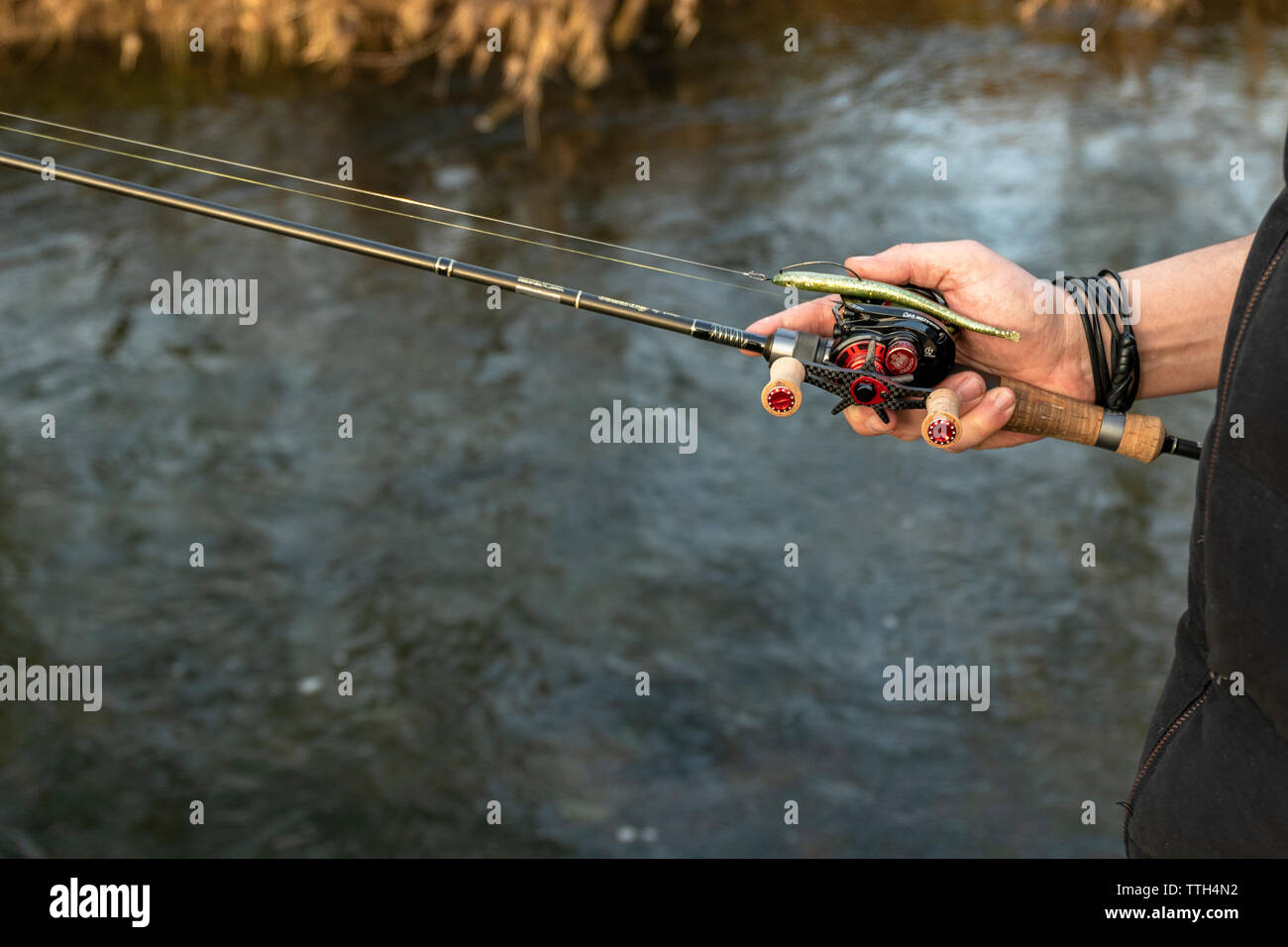 Fisherman holding his fishing rod and bait preparing to launch Stock ...