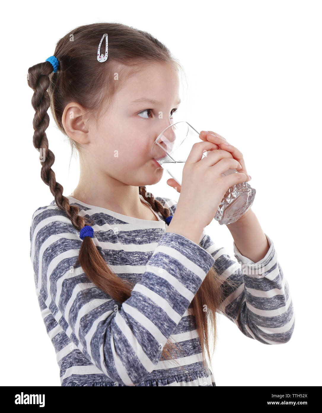 Cute girl drinking water isolated on white Stock Photo - Alamy