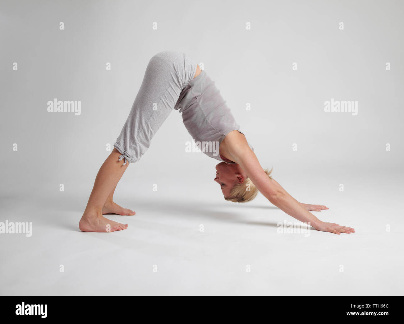 Young female doing yoga pose on clean background Stock Photo - Alamy
