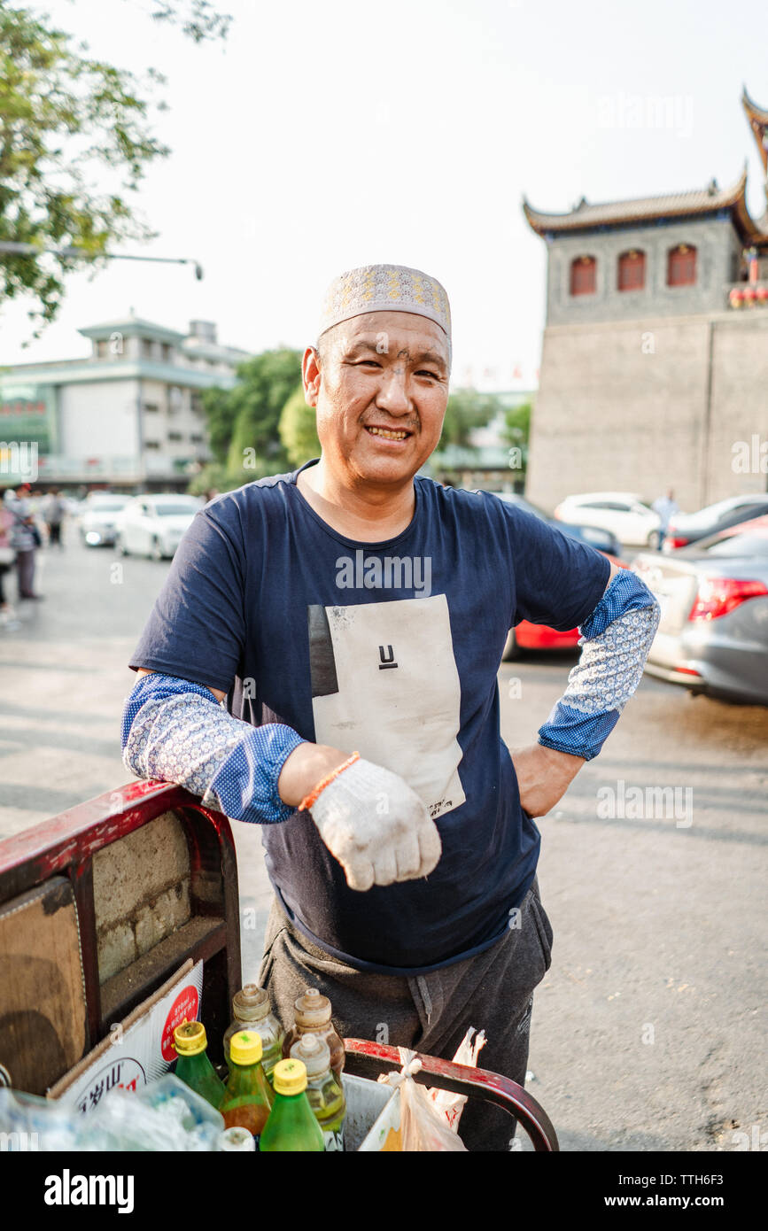 Street Vendor Man working in Urban Western China Stock Photo - Alamy