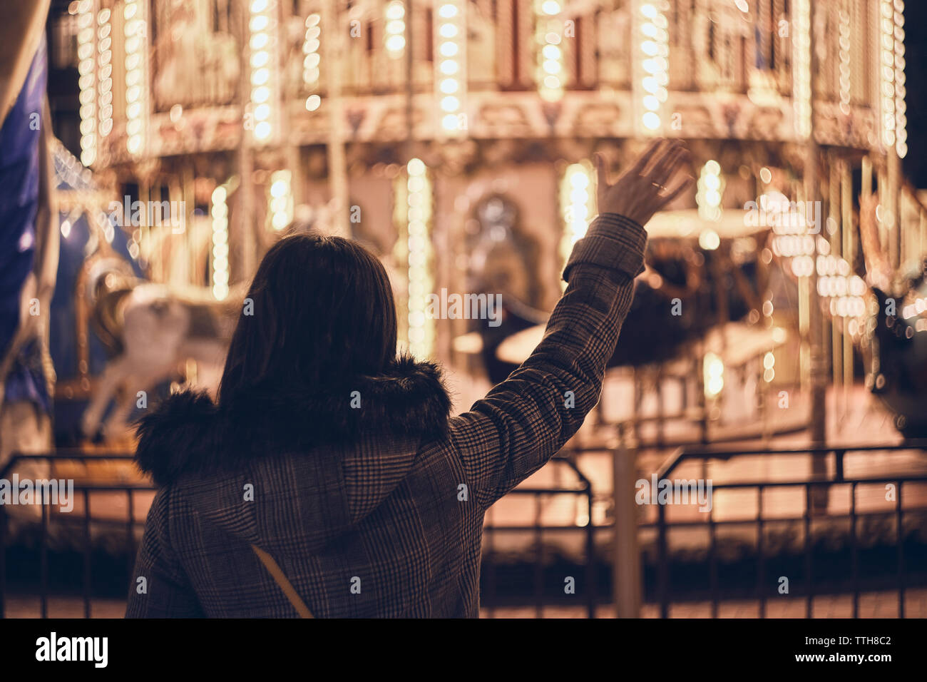 Back View Of A Young Woman At The carousel Stock Photo - Alamy