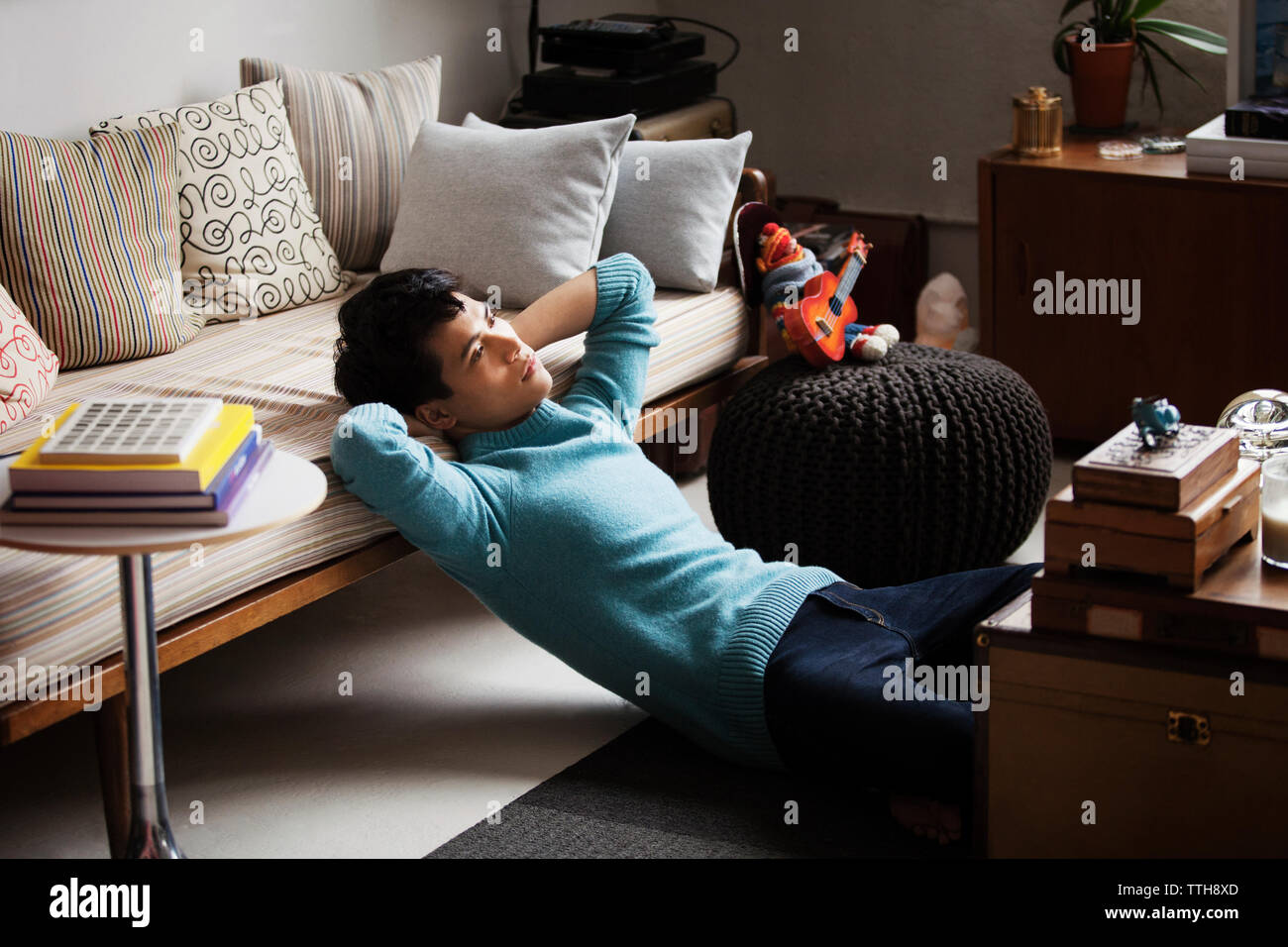 Sad young man sitting home hi-res stock photography and images - Alamy