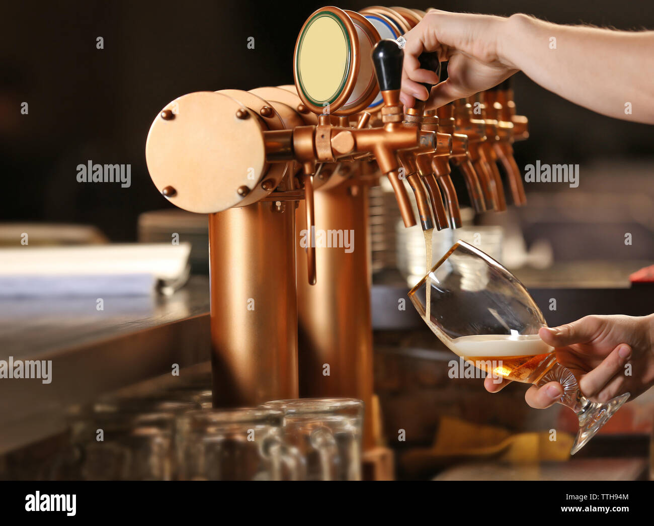 Barman hands pouring a lager beer in a glass Stock Photo - Alamy