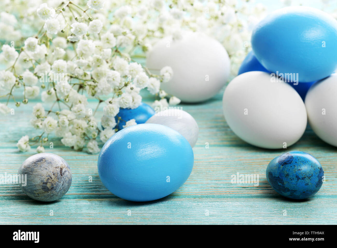 Blue and white Easter eggs with flowers on wooden table closeup Stock ...
