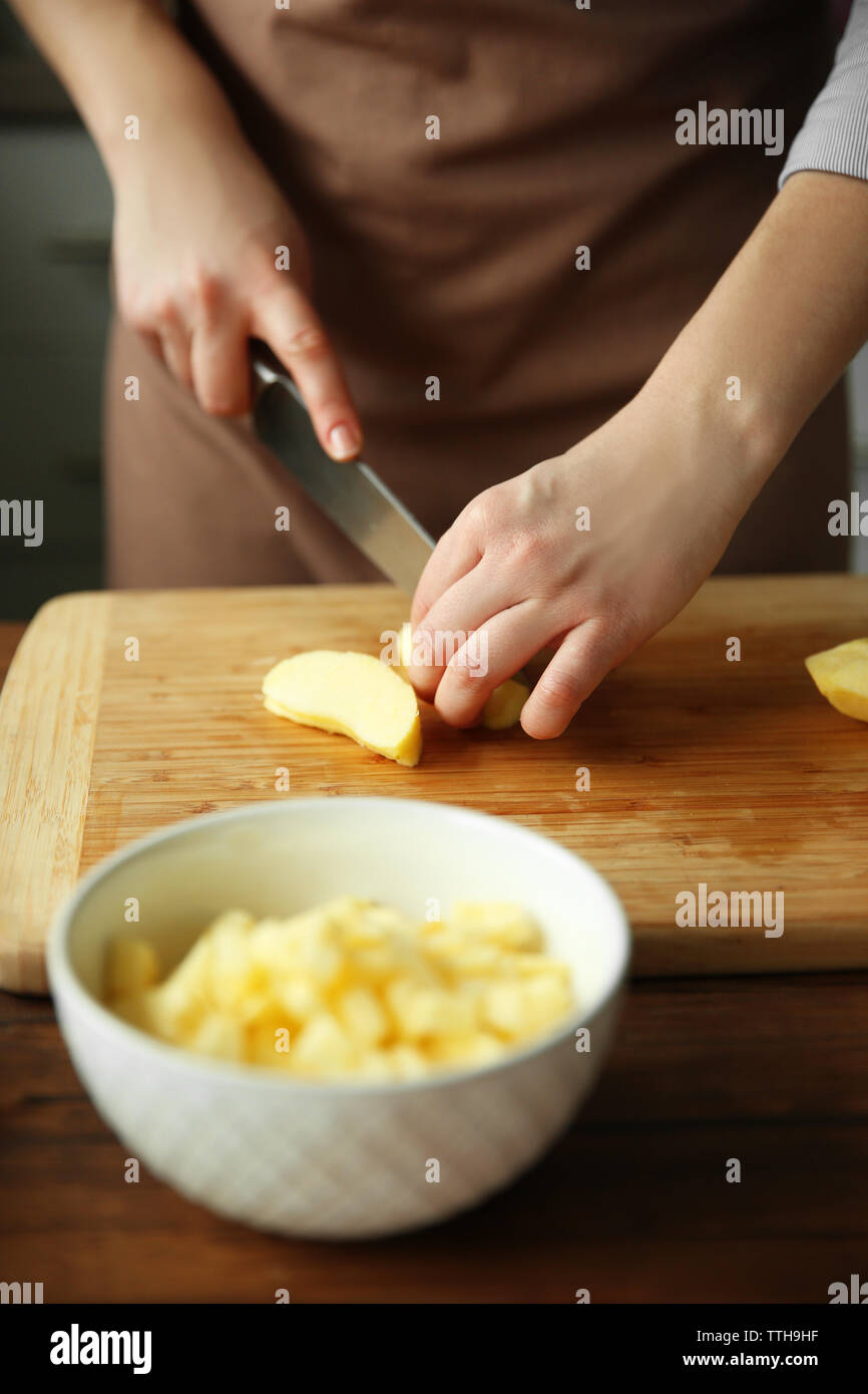 Woman chopping ripe apple on a cutting board Stock Photo - Alamy