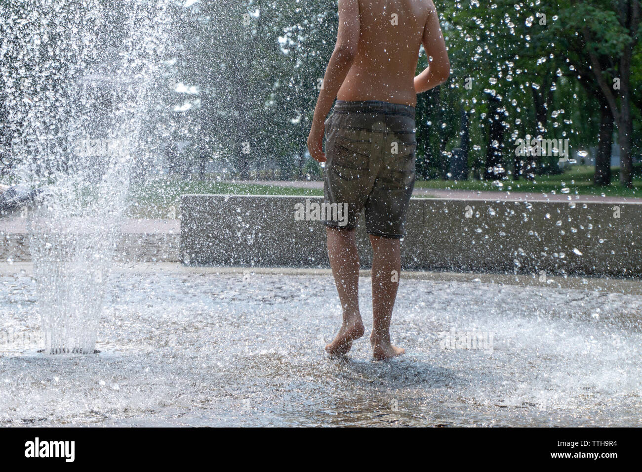 Running through the sprinkler hi-res stock photography and images - Alamy