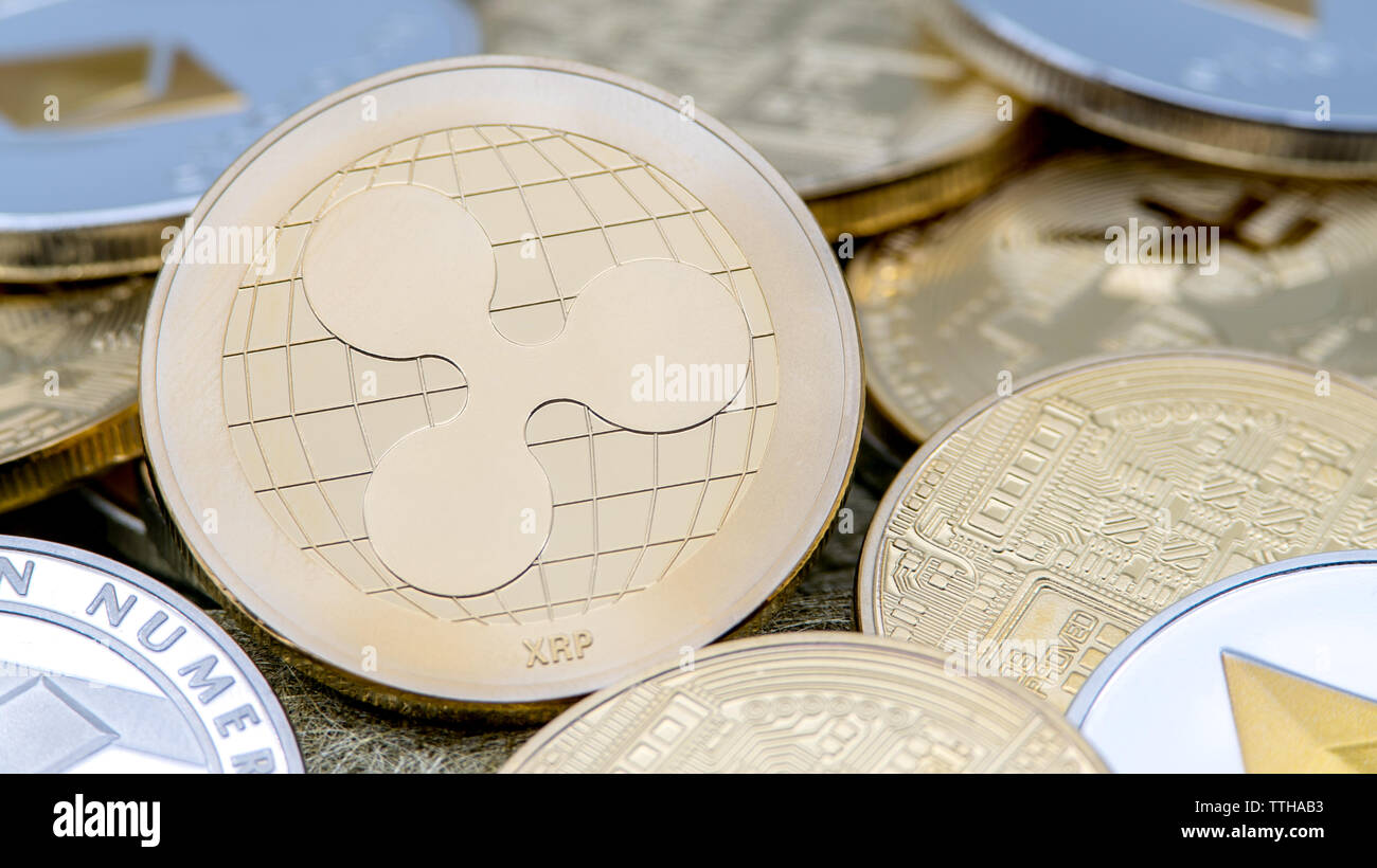 Physical metal golden Ripplecoin currency over others coins. Worldwide ...