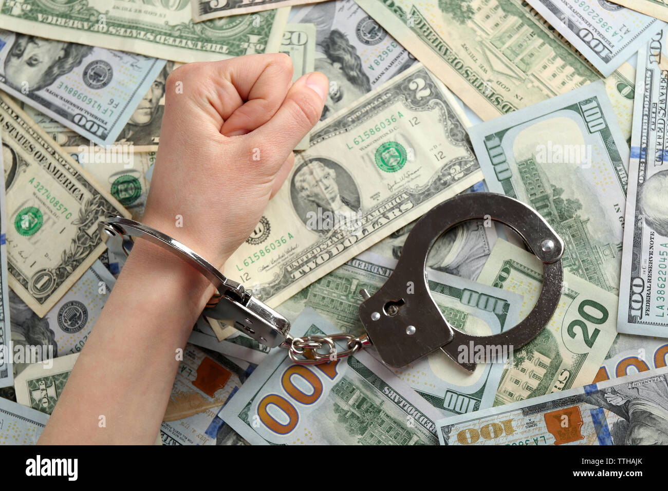 Hand in handcuffs on dollar banknotes. Corruption concept Stock Photo ...