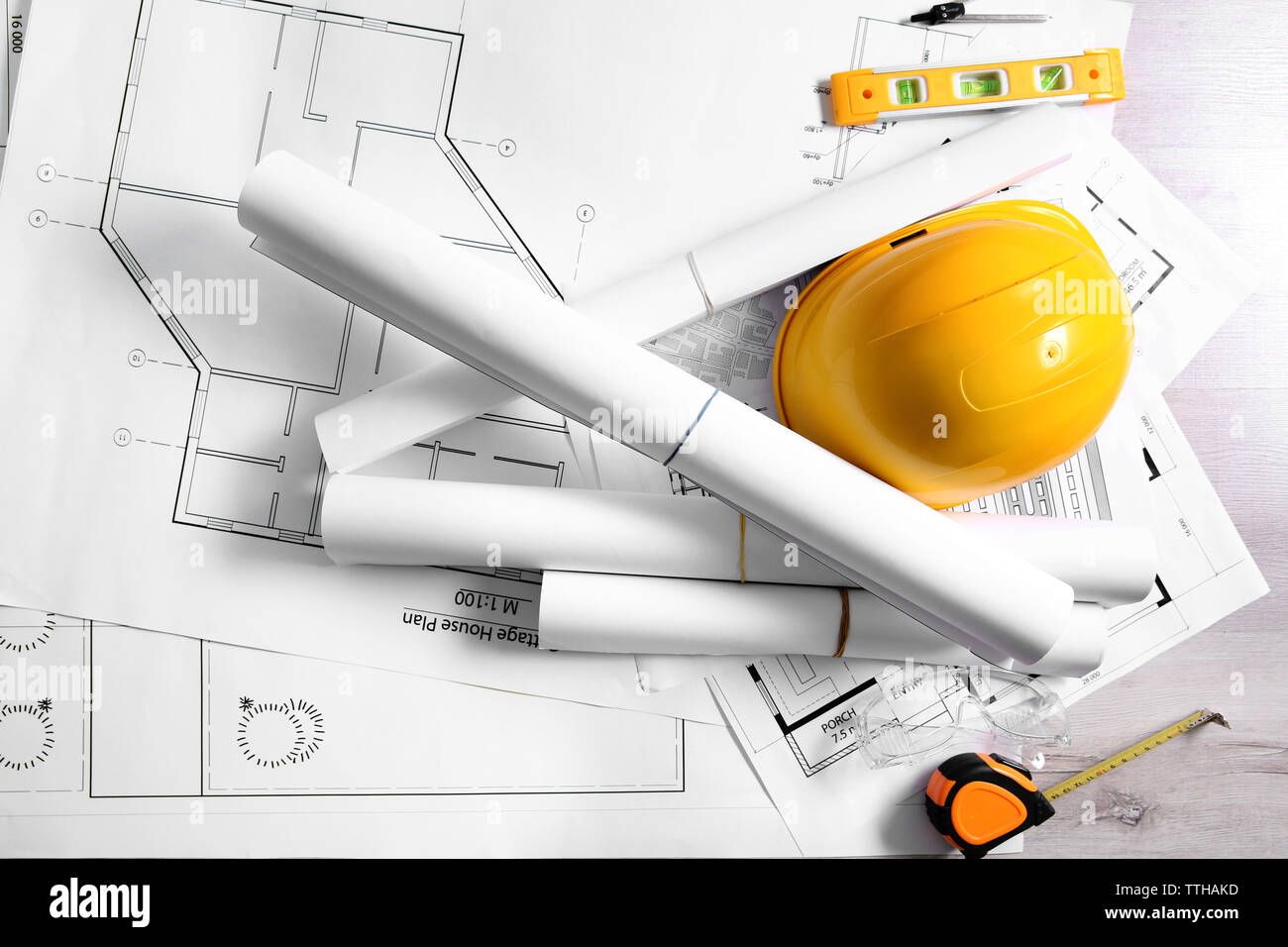 Project drawings and yellow helmet, top view Stock Photo - Alamy