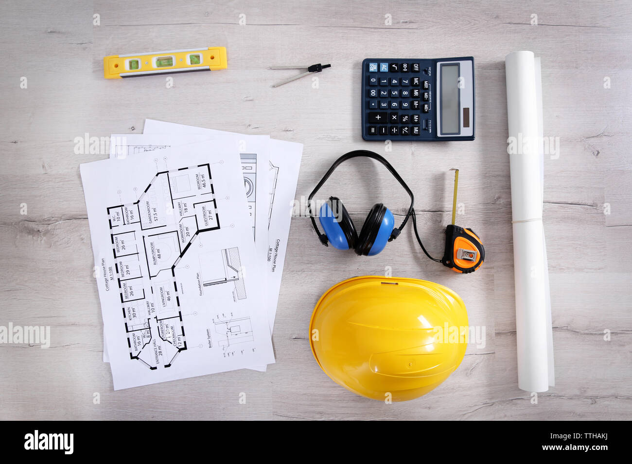 Project drawings and yellow helmet, top view Stock Photo - Alamy
