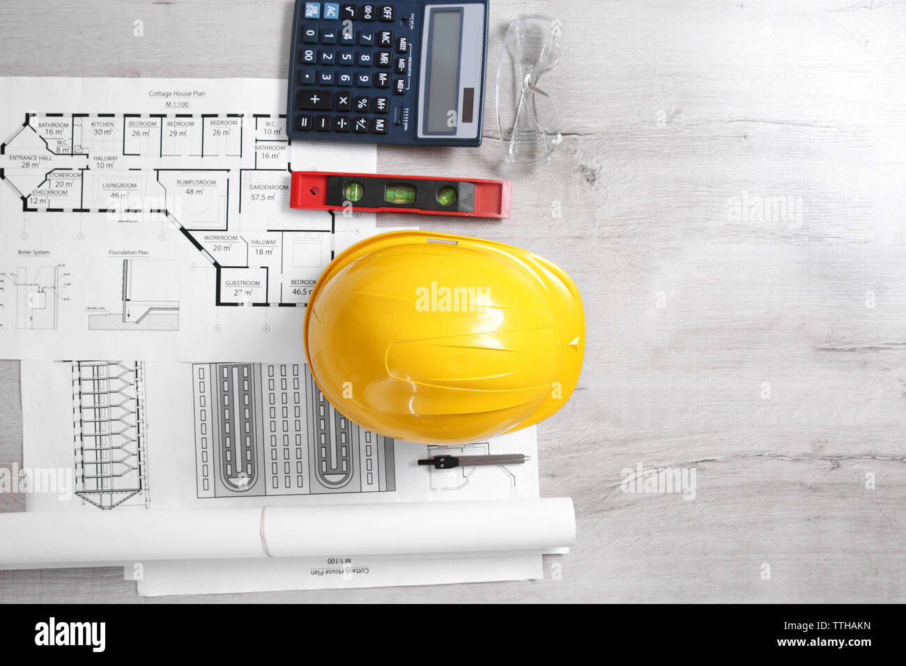 Project drawings and yellow helmet, top view Stock Photo - Alamy