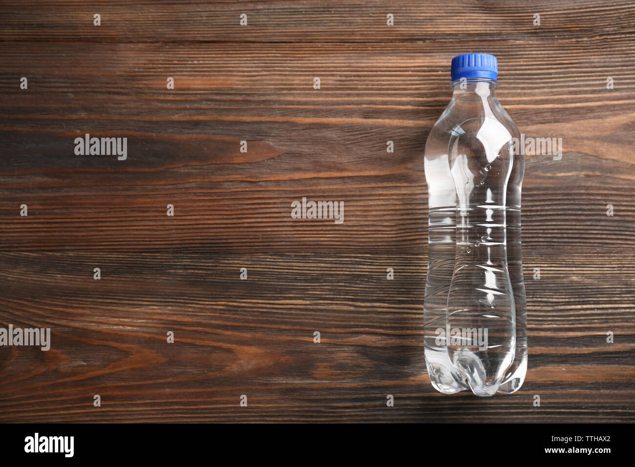 Bottled water on the wooden table, top view Stock Photo - Alamy