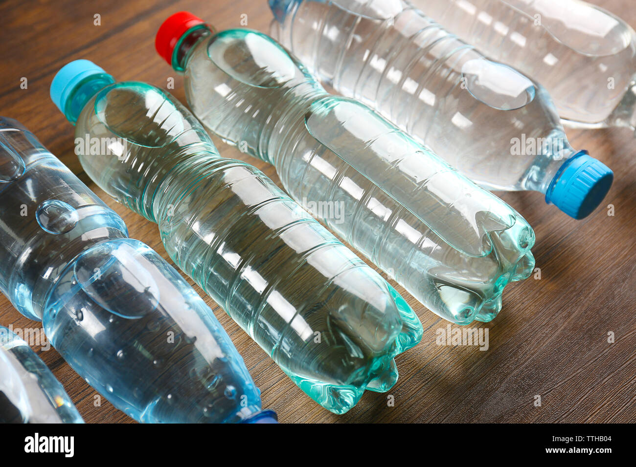 Bottled water on the wooden table, close up Stock Photo - Alamy