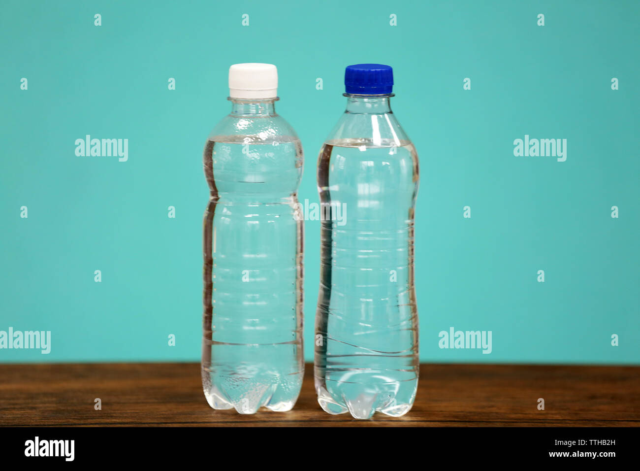 Two bottles of water on the blue background Stock Photo - Alamy