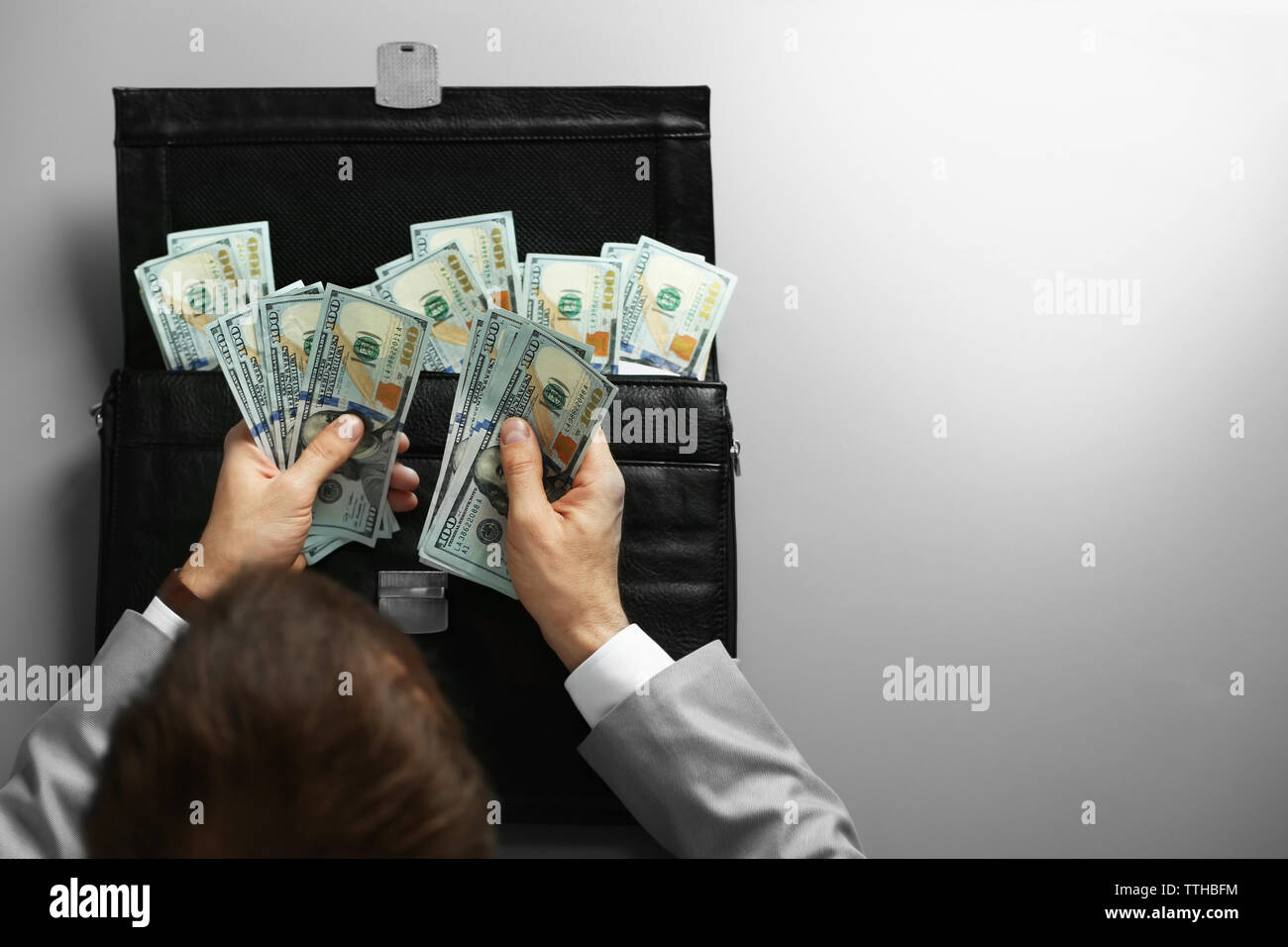 Businessman counting money Stock Photo - Alamy