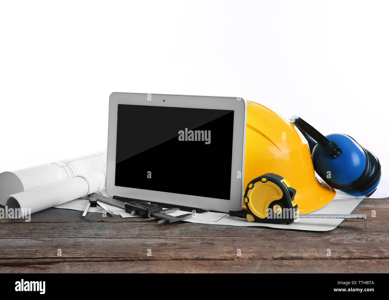 Tablet and blueprints on a white background Stock Photo - Alamy